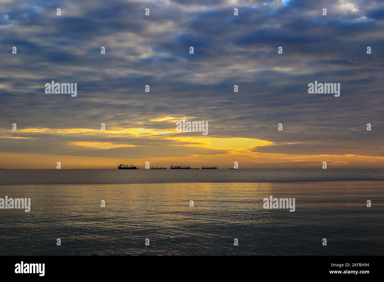 Sunrise over the Baltic Sea with a view of ships sailing on the horizon ...