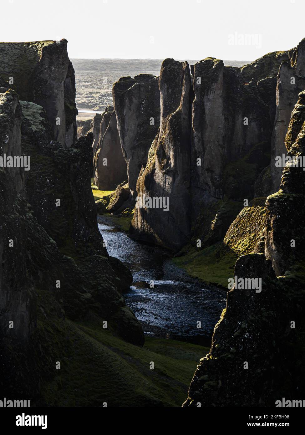 River passing through a crevice ending in the ocean in soft light Stock ...