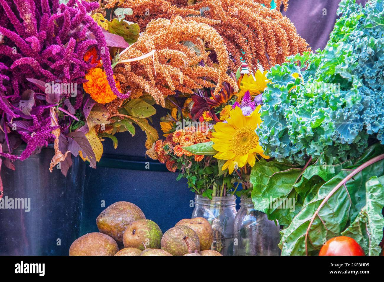 Flowers in canning jars and buckets and vegetables and fruit at farmers ...