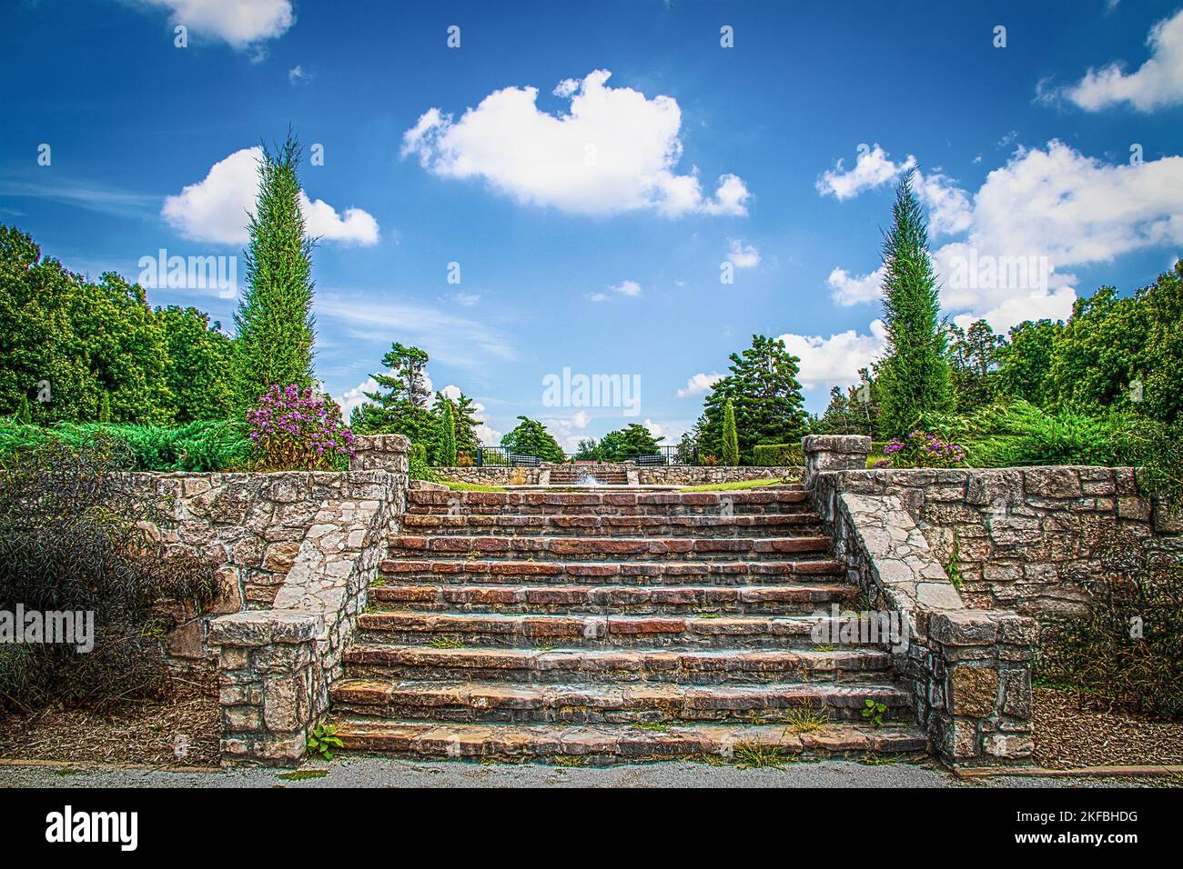 Formal garden - rough hewn rock steps to higher terraced level with ...