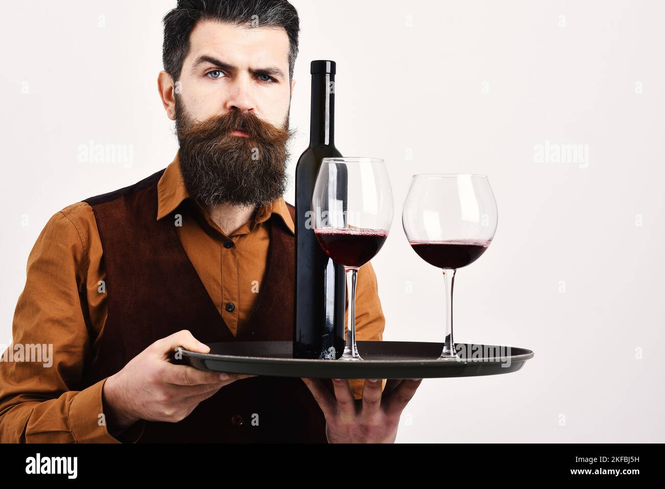 Man with beard holds alcohol on white background Stock Photo - Alamy