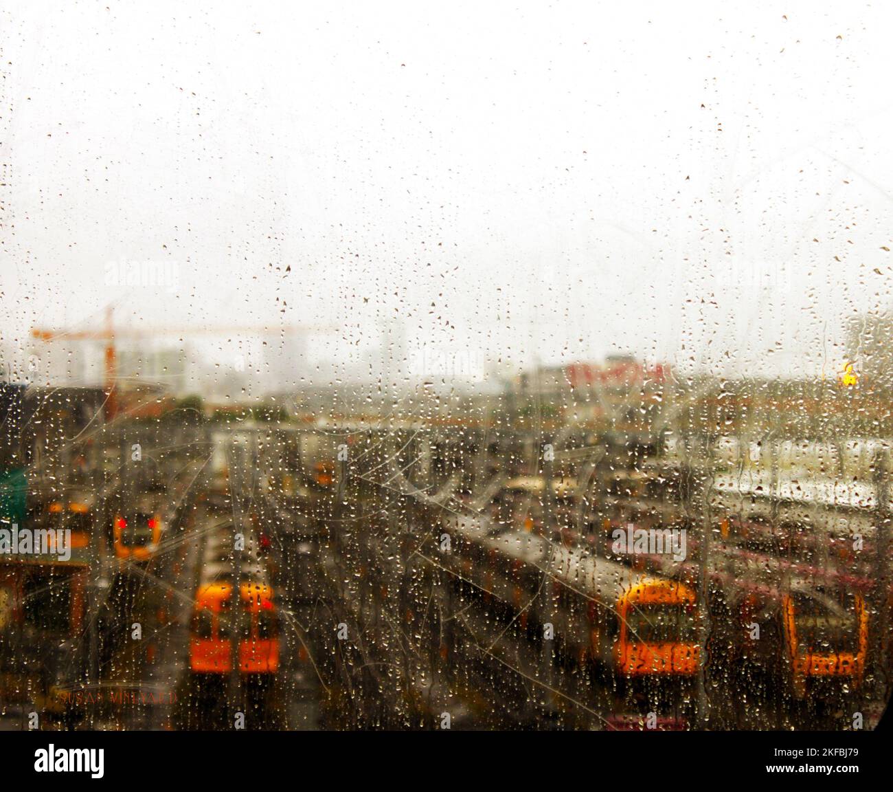 Looking through scratched window with raindrops at trains parked on ...