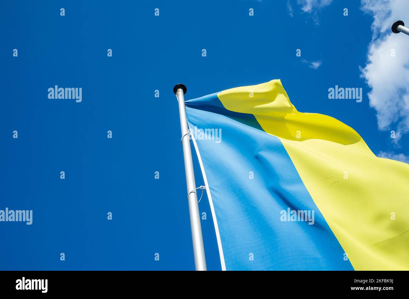 Flag of Ukraine on a background of blue sky with clouds. State symbol ...