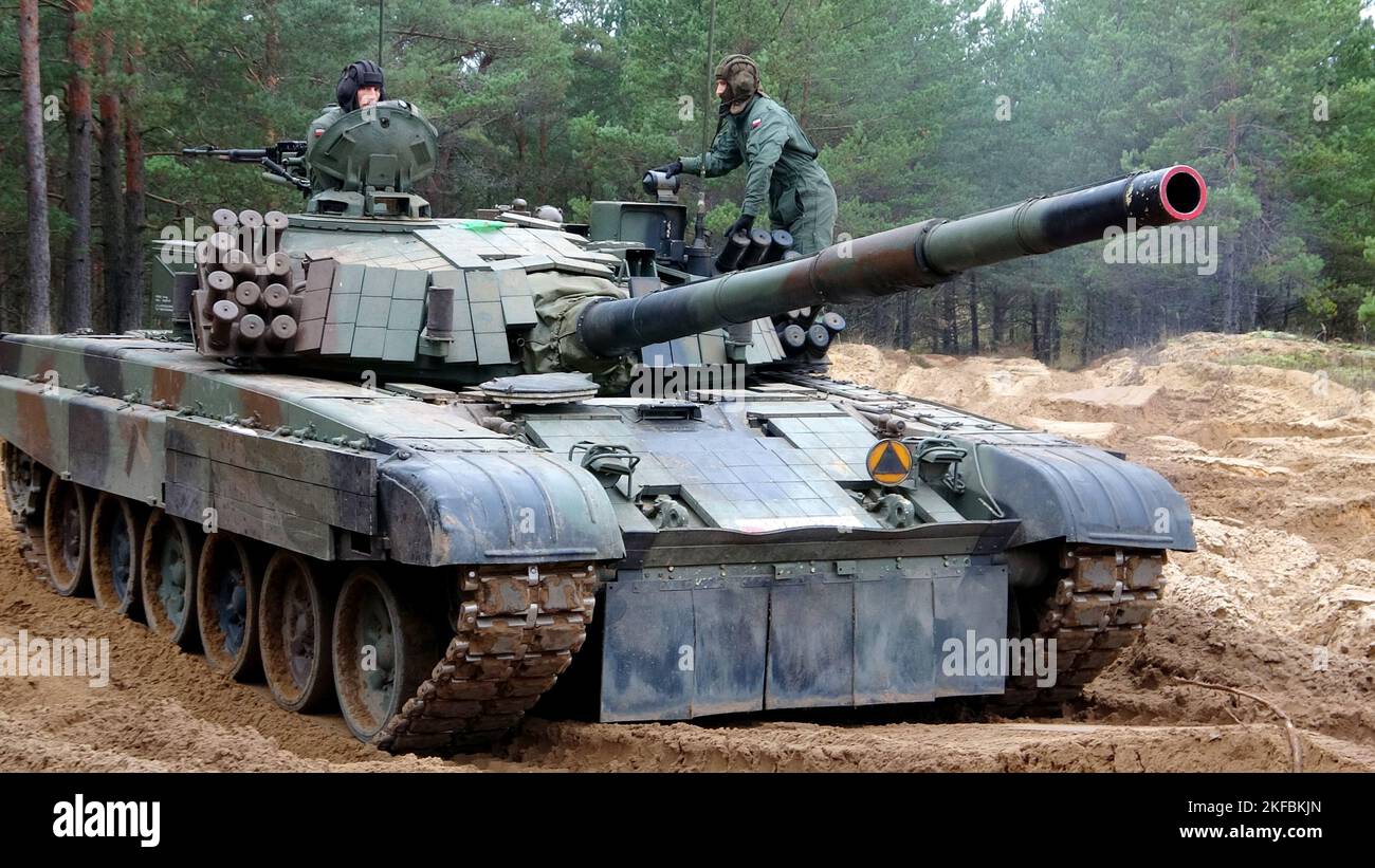 A Polish crew is shown on a tank during a NATO exercise at Camp Adazi ...