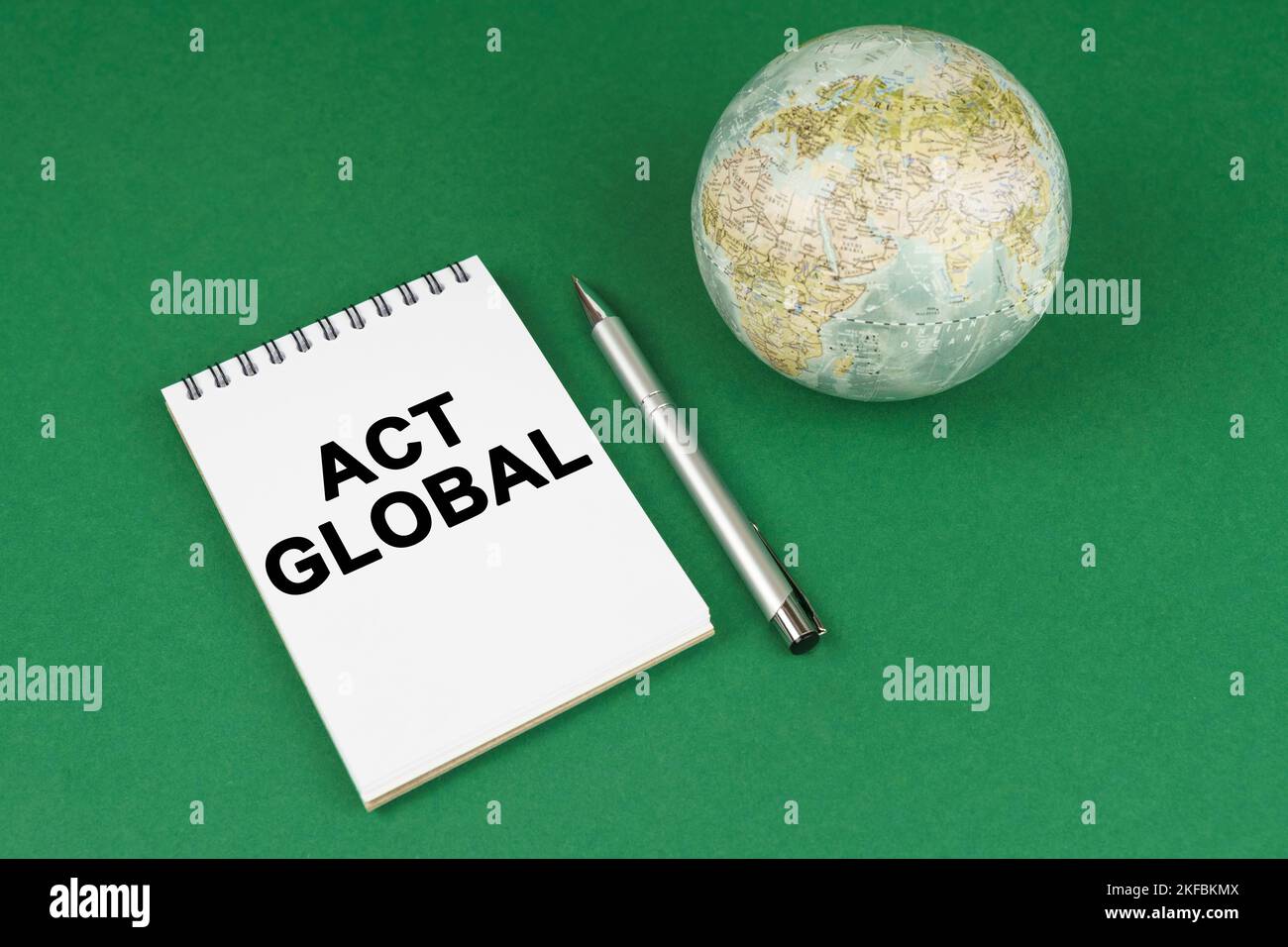 Global concept. On a green surface lies a model of the planet and a ...