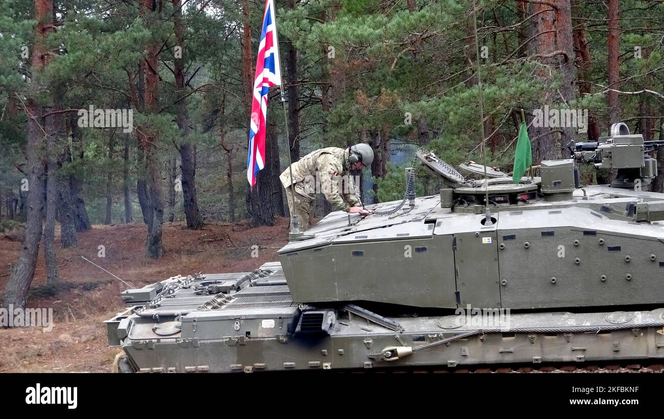 A British soldier checks equipment on a tank during a break in a NATO ...