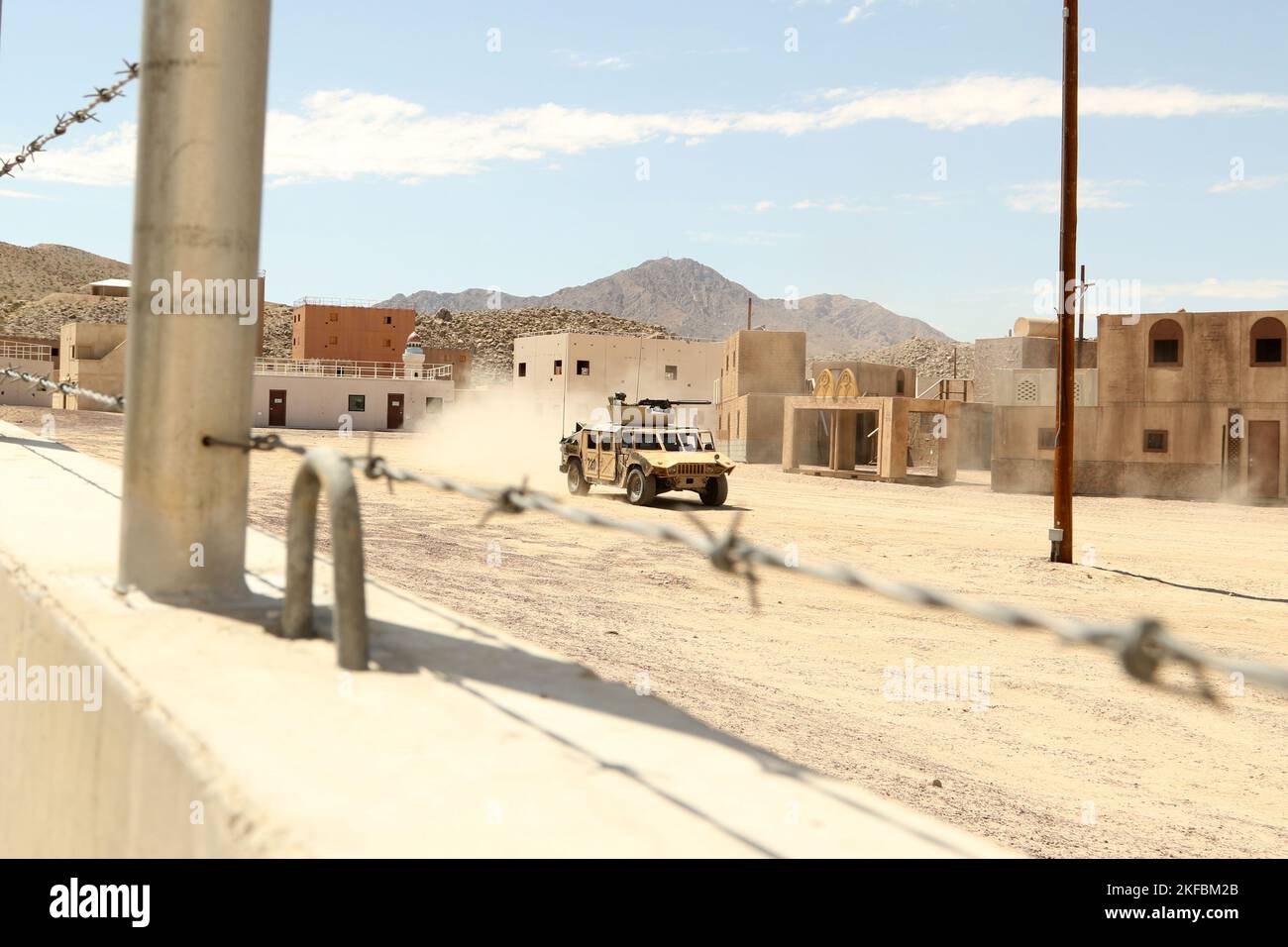 U.S. Army HMMV drives into a hostile training environment during a ...