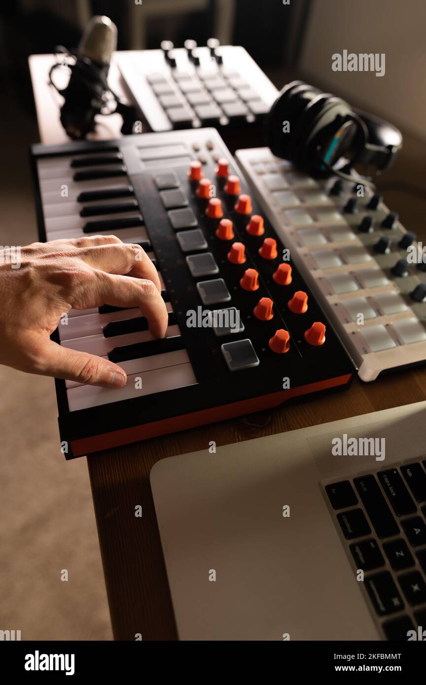 The musician plays the synthesizer, midi keyboard. Close-up. Recording ...