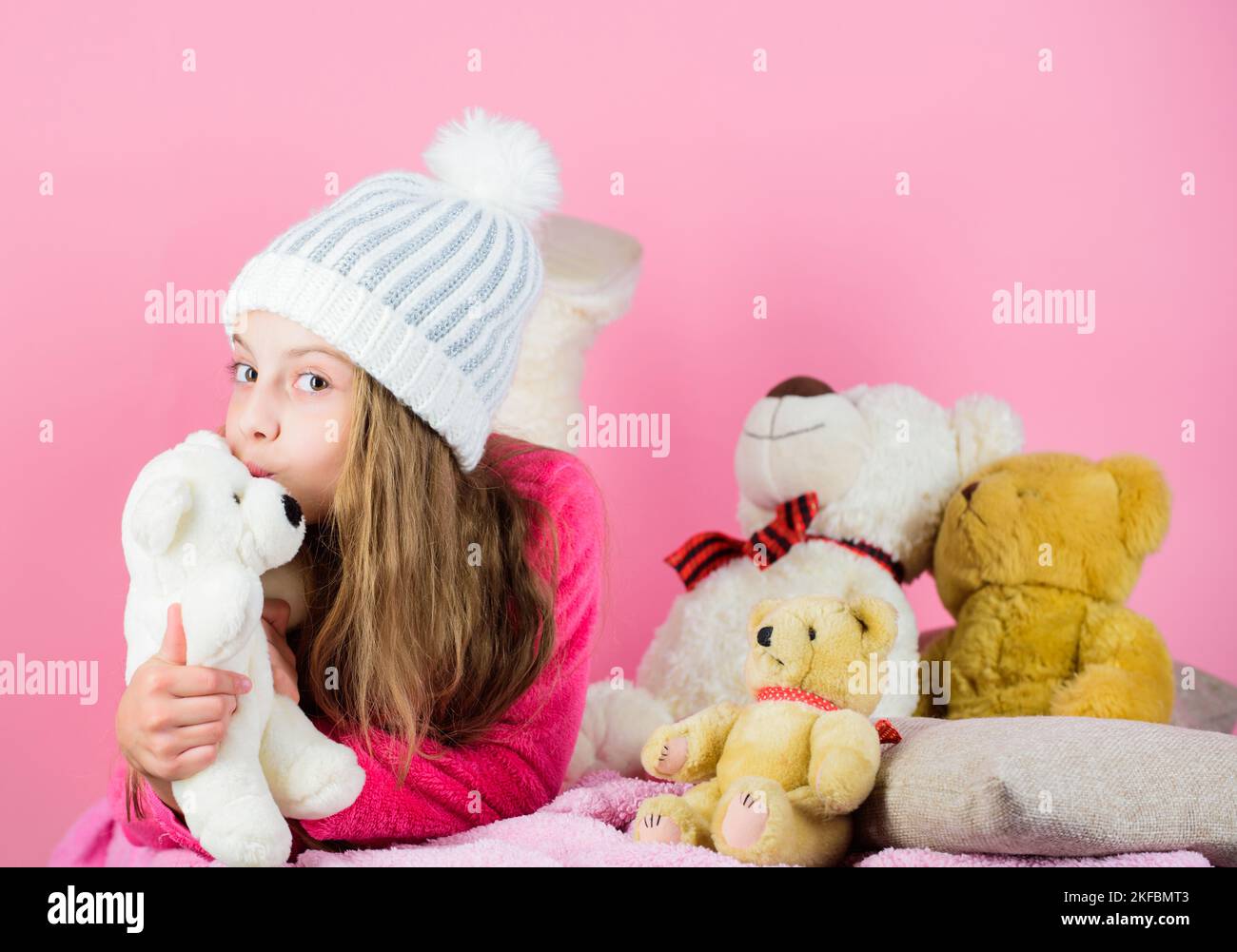 Child small girl playful hold teddy bear plush toy. Kid little girl ...