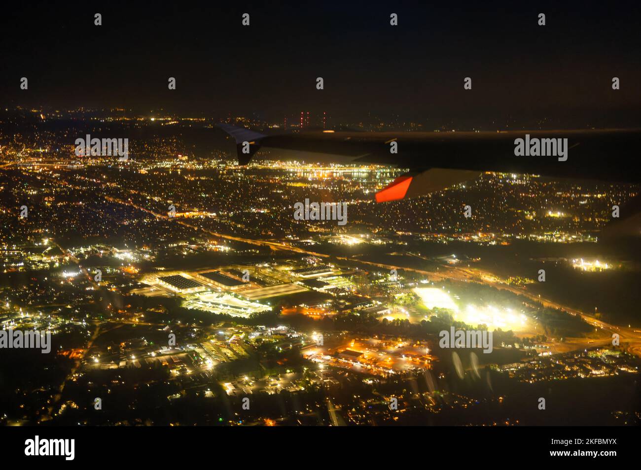 Night metropolis illuminated by golden lights from a bird's eye view ...