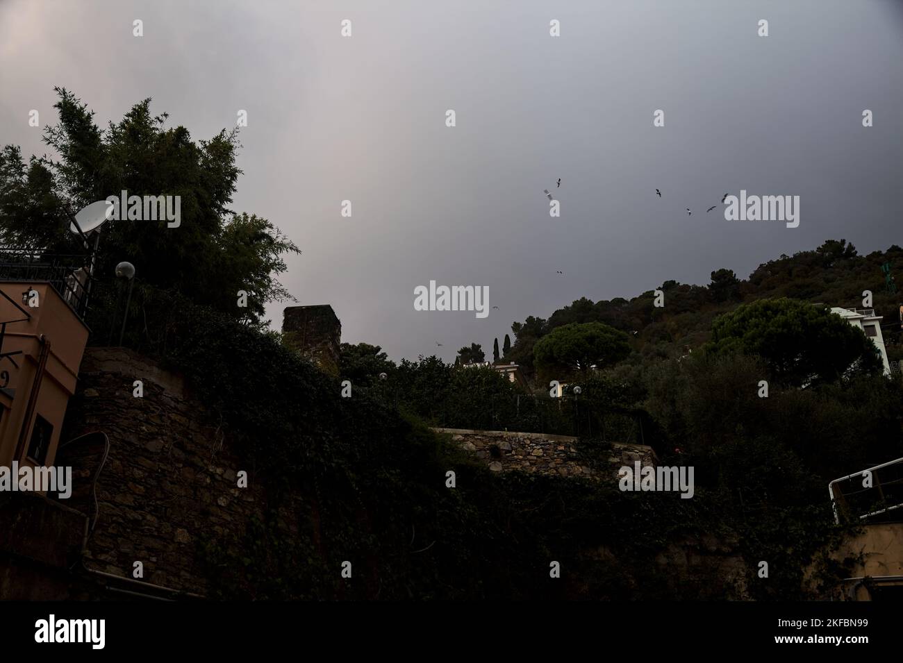 Roof tops and buildings on a cliff in the distance Stock Photo - Alamy