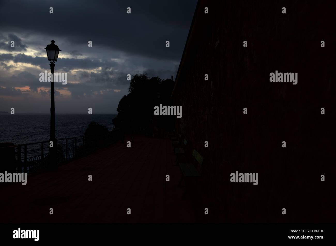 Panoramic walk with street lights on a cliff by the sea at dusk Stock ...