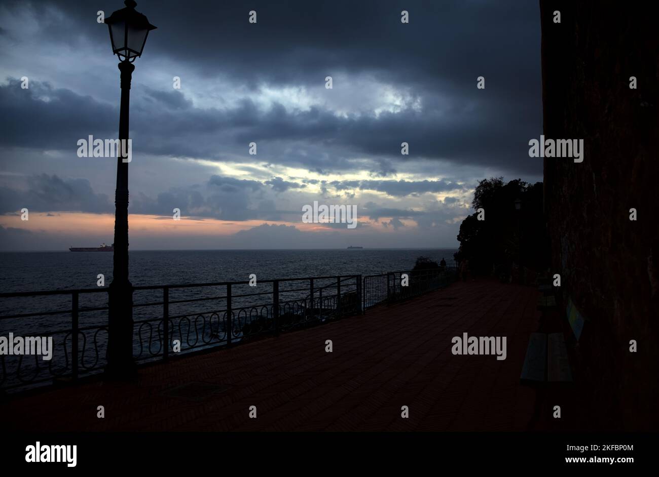Panoramic walk with street lights on a cliff by the sea at dusk Stock ...