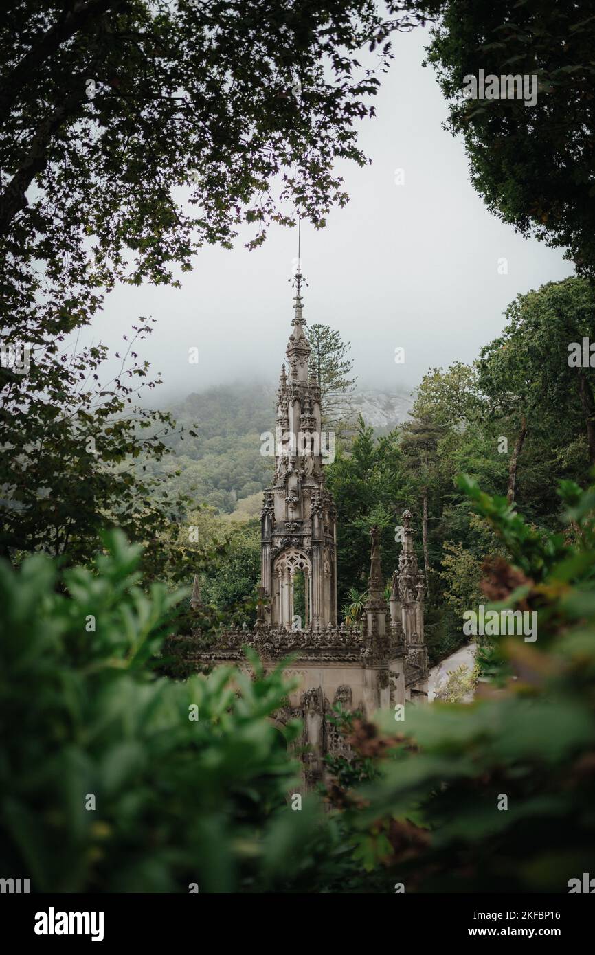 The Quinta da Regaleira castle in a distance with wood trees in Sintra ...