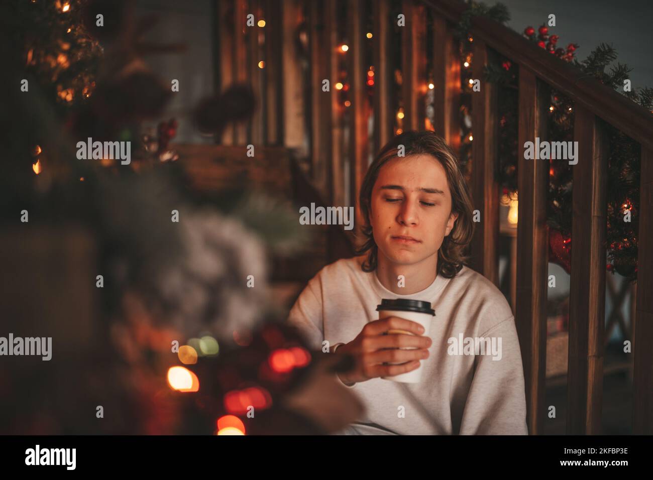 Young teen boy with long hair thoughtful look sad eyes negative mood ...