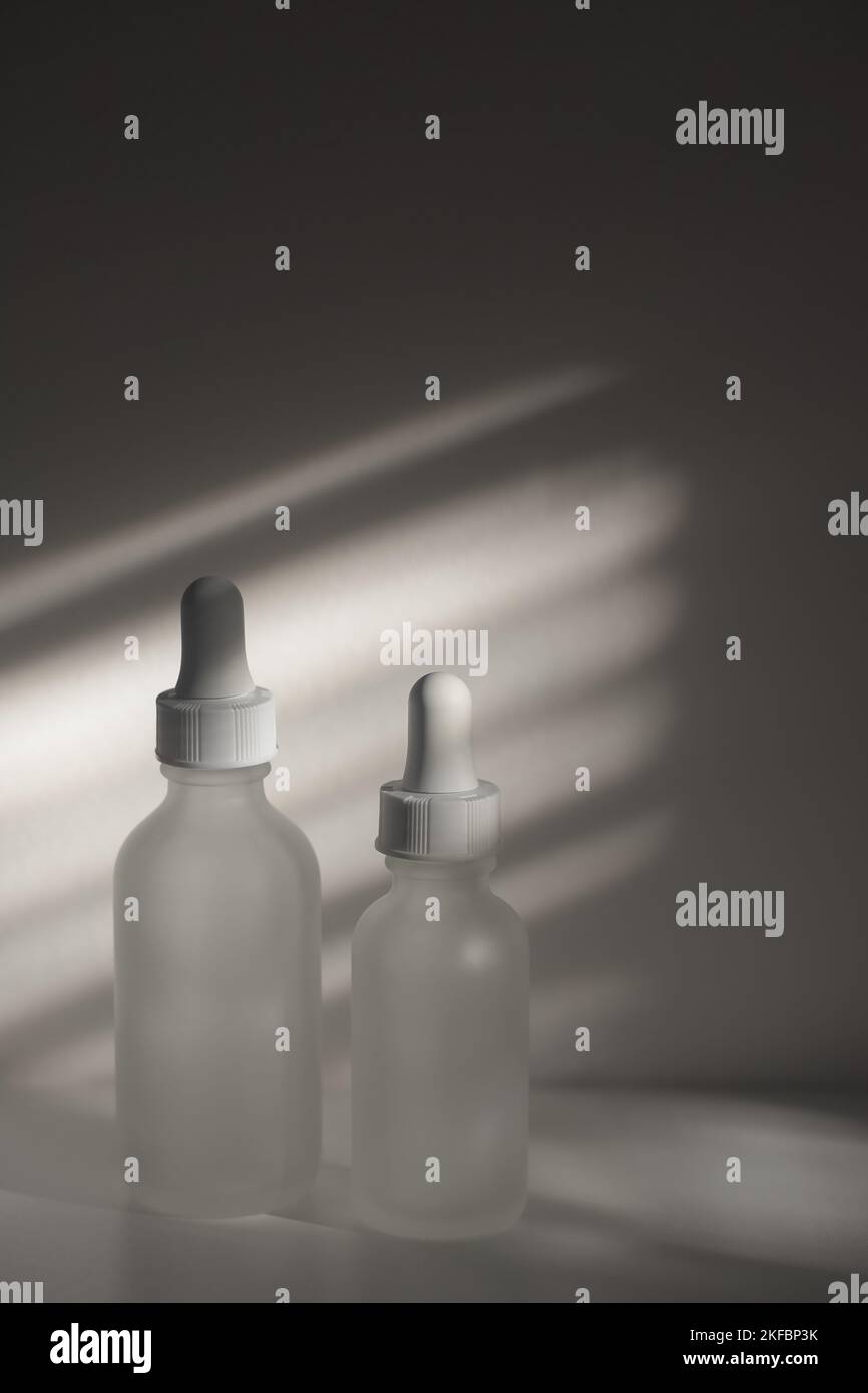 Two empty translucent glass dropper vials. Different-sized bottles on ...
