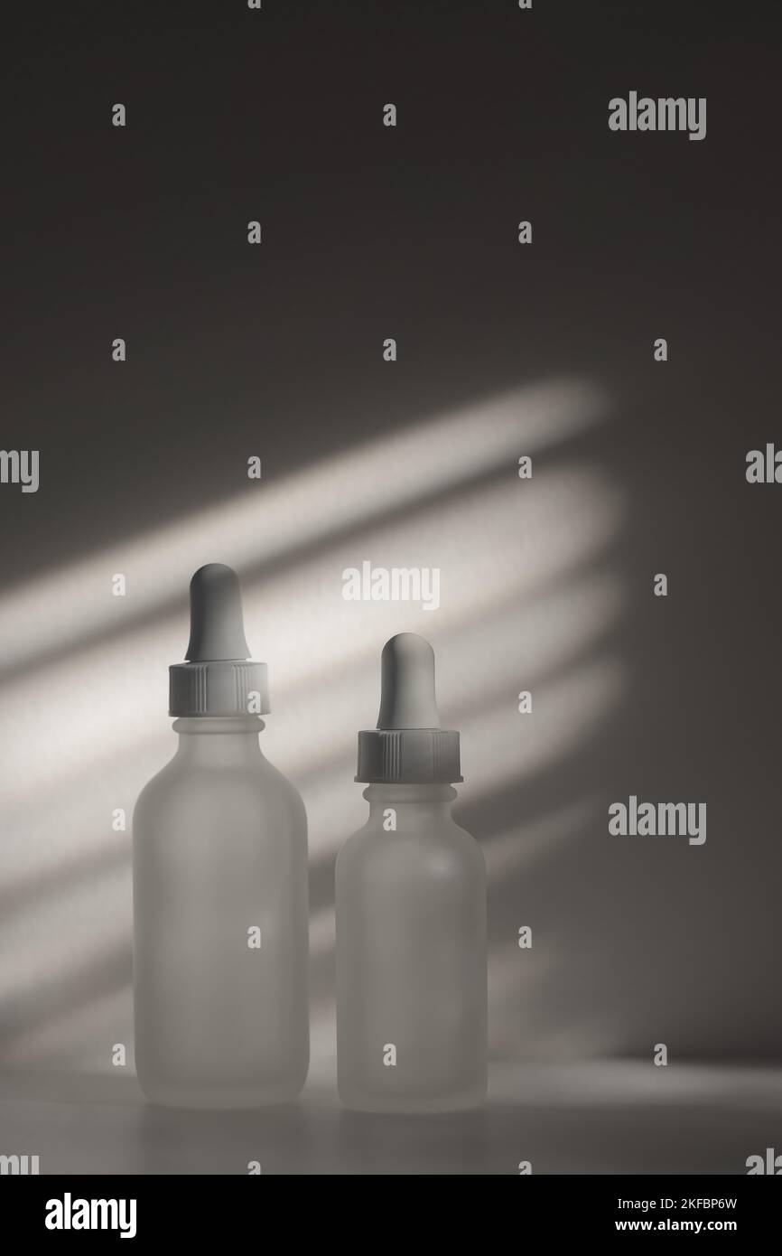 Two empty translucent glass dropper vials. Different-sized bottles on ...