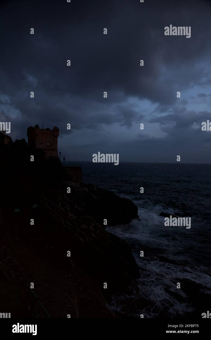 Watchtower on a cliff by the sea on a cloudy day at dusk Stock Photo ...