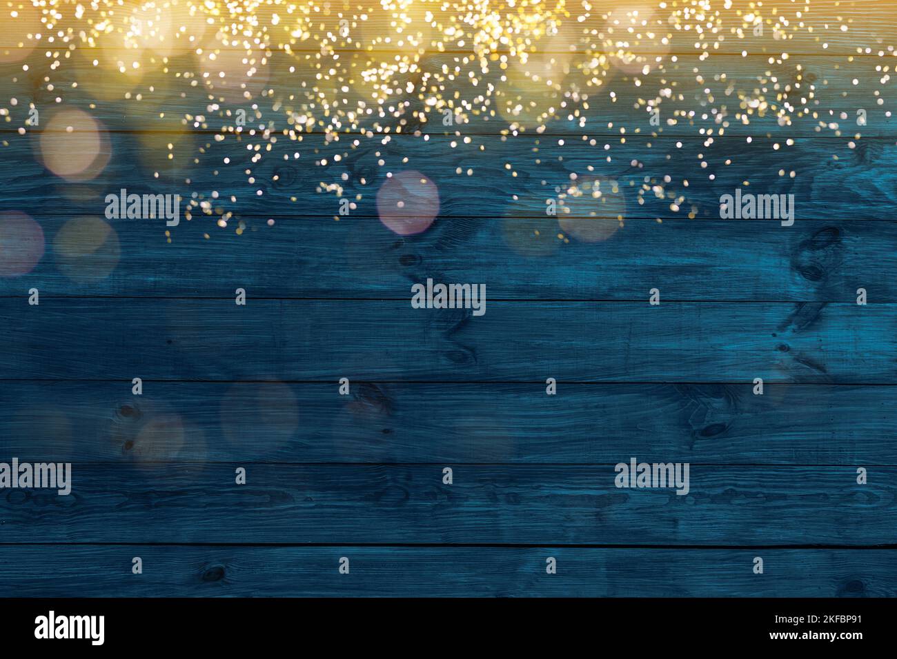 Glowing Christmas tree garland in the form of a frame on a blue wooden ...