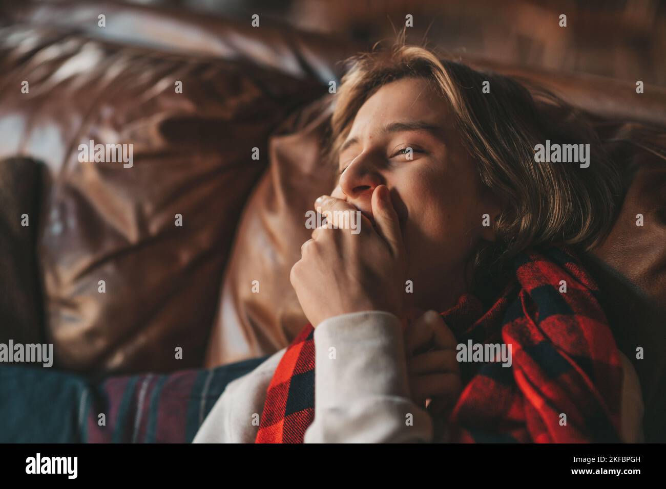 Young emotional cheerful teen boy with long hair laughter and joyful at ...