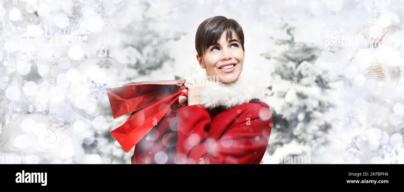 happy smiling woman with merry christmas shopper red gift bags ...