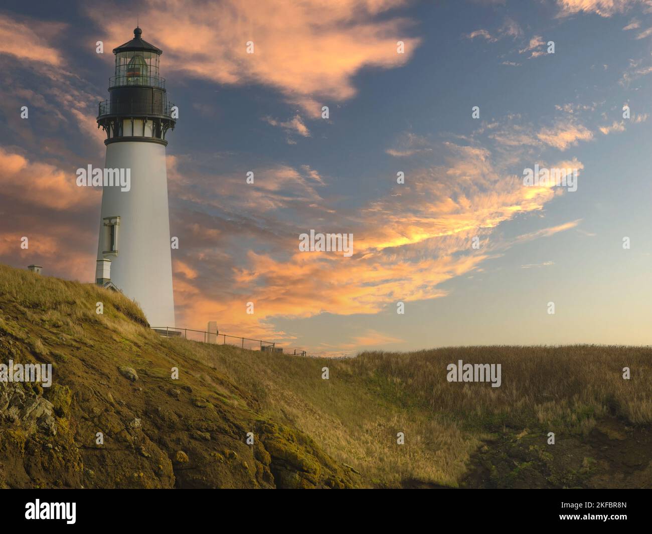 Panoramic shot. A beautiful white lighthouse on a high green ocean ...