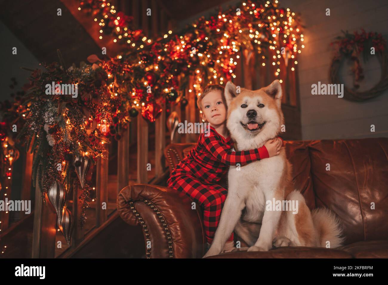 Smile small child having fun with dog waiting for miracle Santa at noel ...