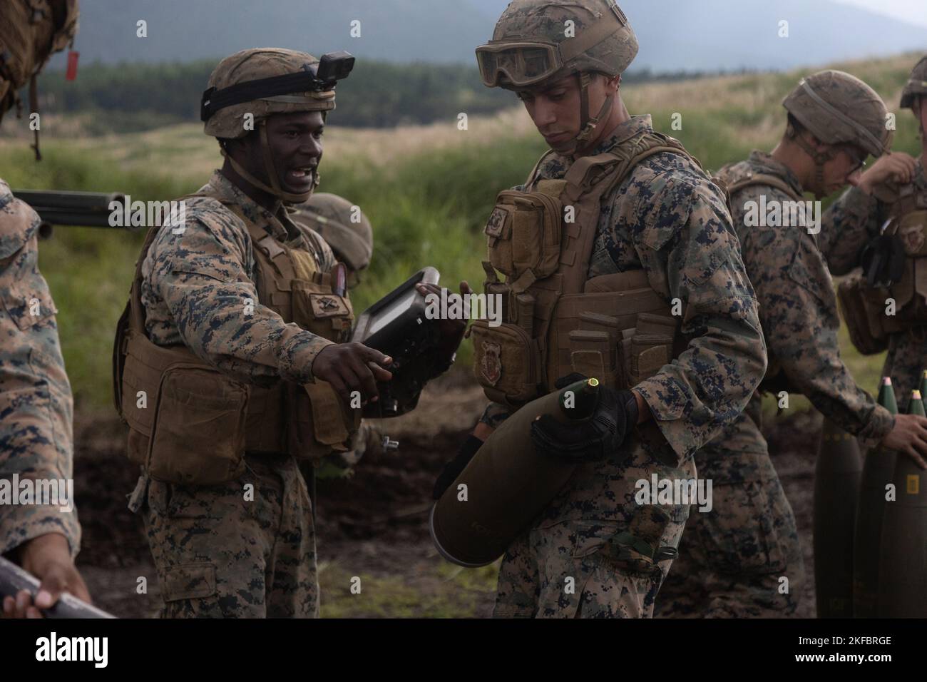 U.S. Marine Corps Sgt. John Campbell, left, a section chief and Cpl. Mateo Rios, right, a ...