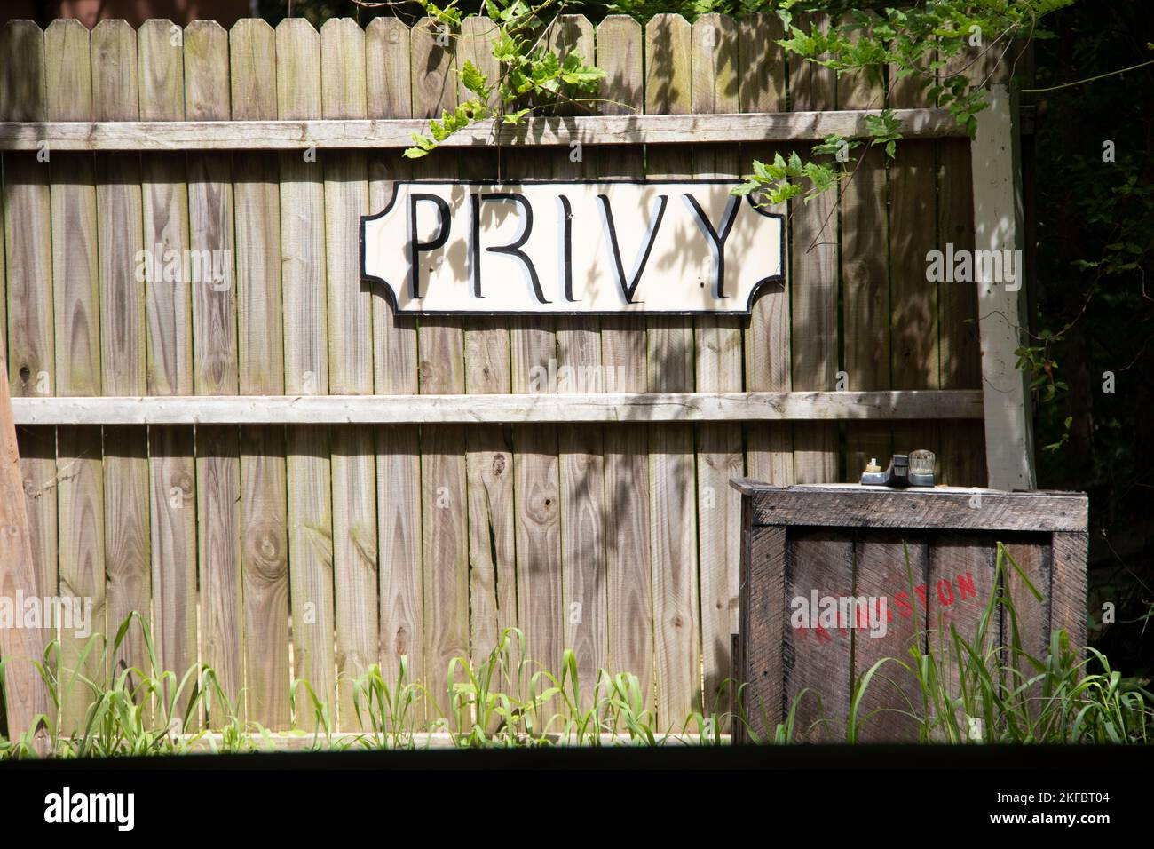 Pirate setting - Privy bathroom sign on wooden fence with wooden crate ...