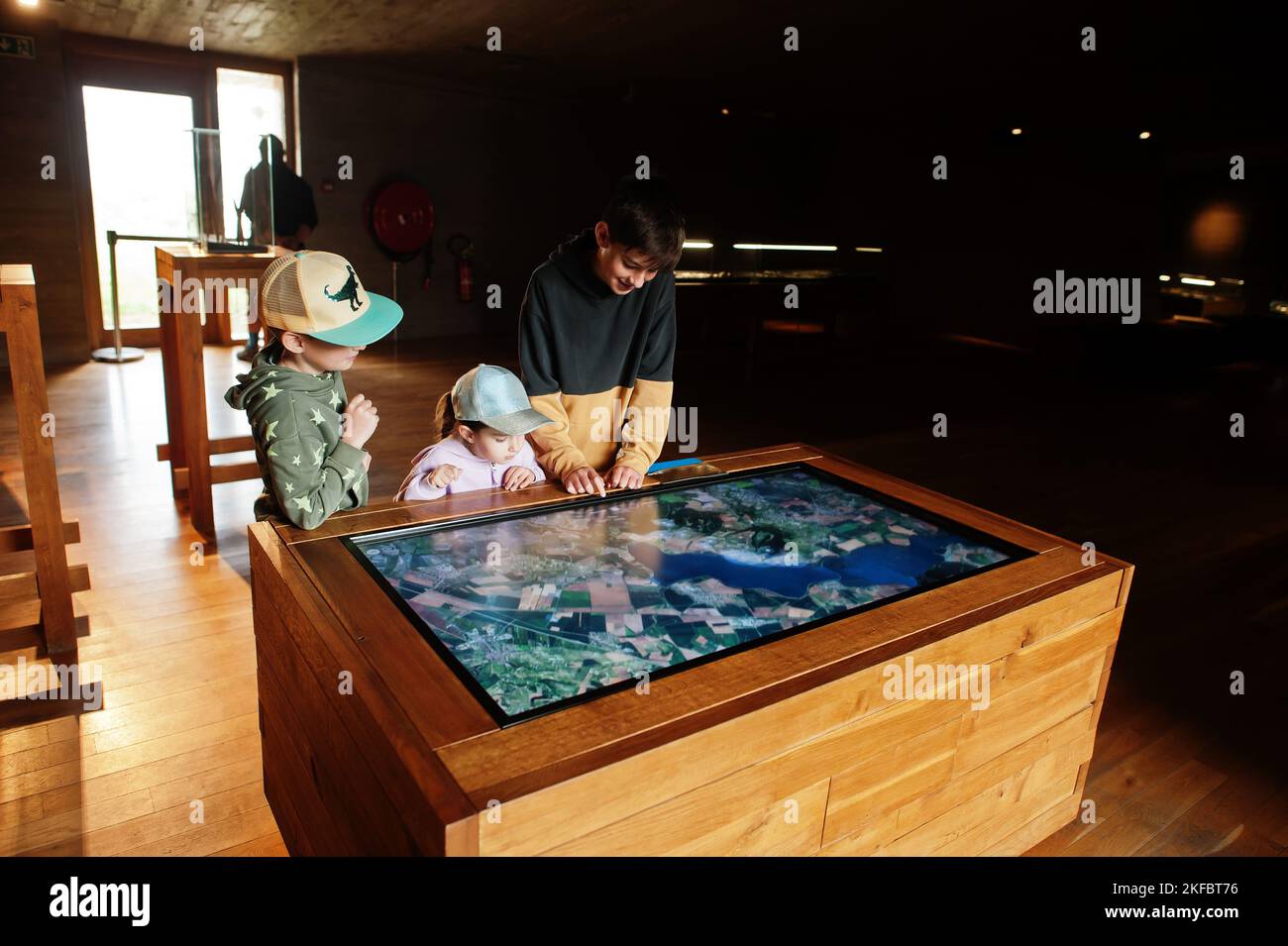 Kids exploring virtuality screen map in museum Stock Photo - Alamy