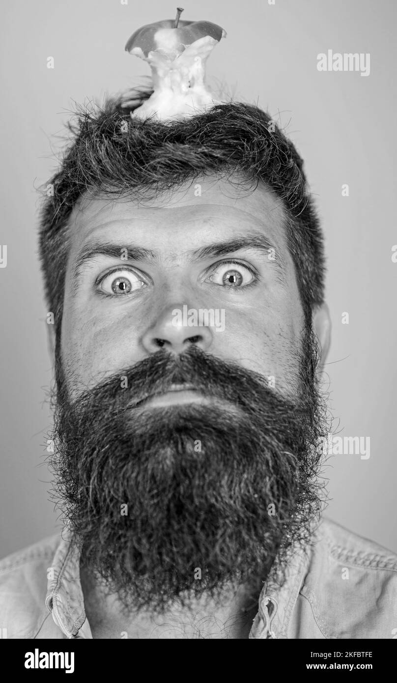 Hipster shocked face with apple stump target on head blue background ...