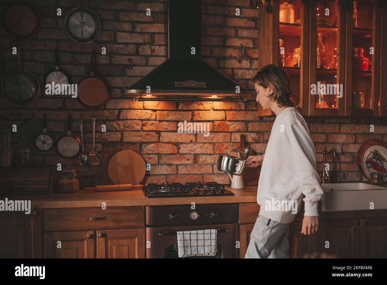 Young teenage boy with long hair in morning routine and preparing on ...