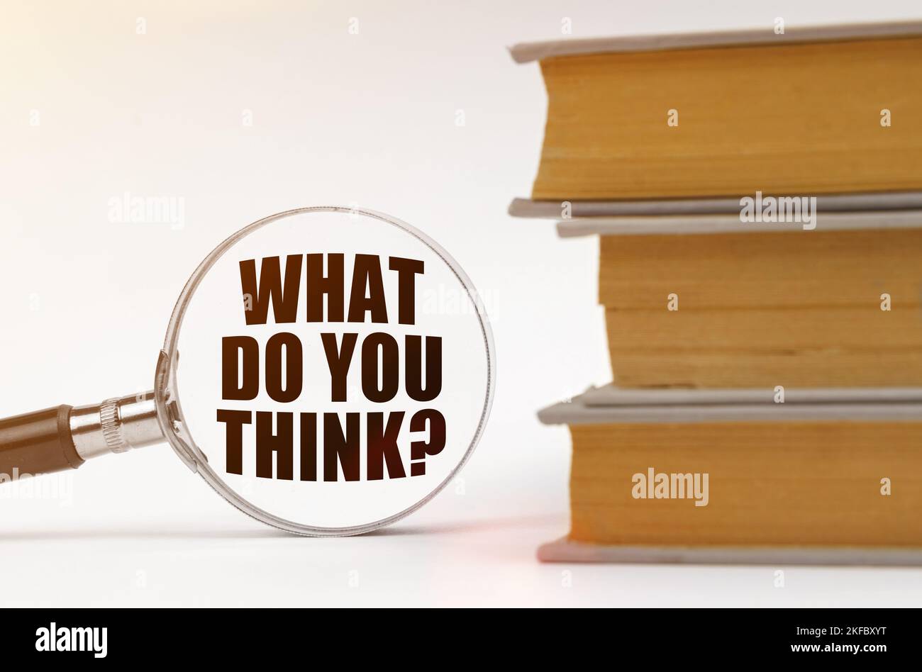 Education concept. On a white background, books and a magnifying glass ...