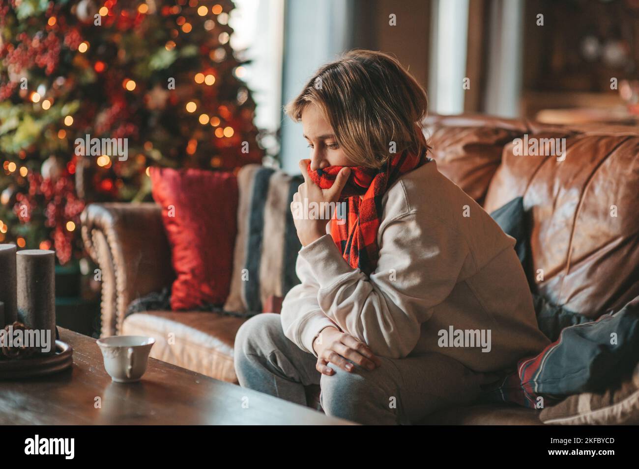 Young teen boy with long hair thoughtful look sad eyes negative mood ...