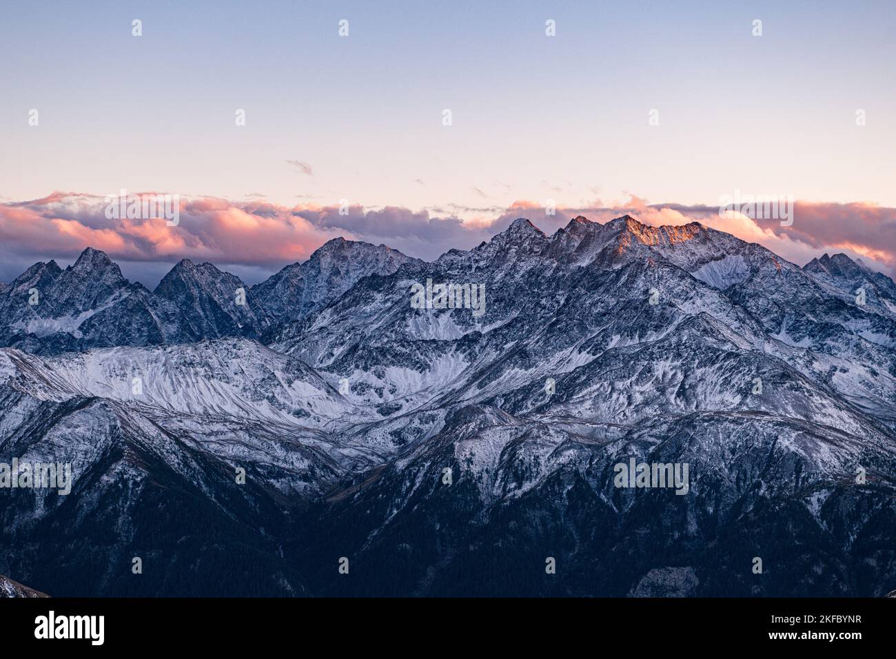 A beautiful scenery of the snow covered Austrian alps with a sunset sky ...