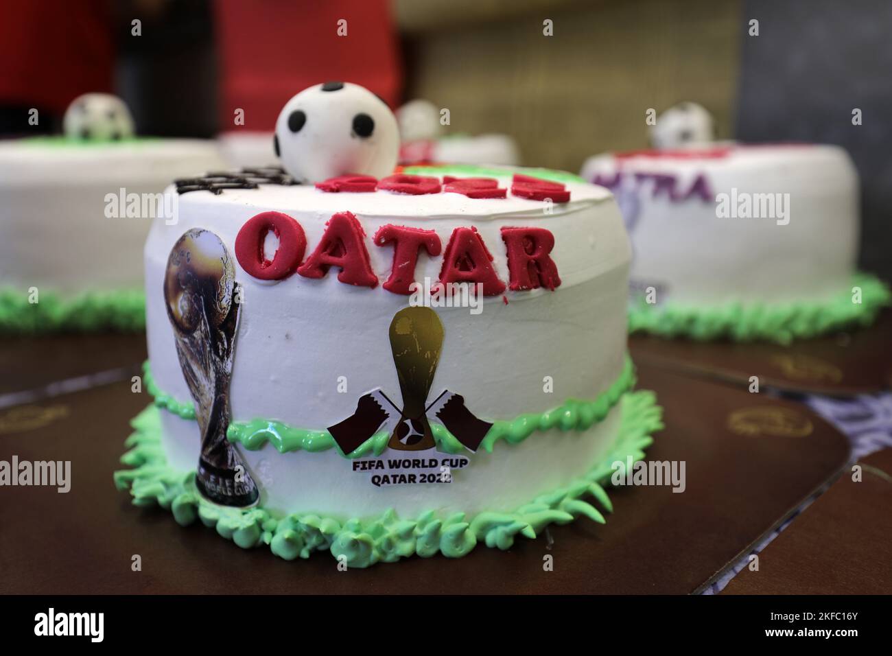A Palestinian baker shows a cake decorated with items linked to Qatar's ...