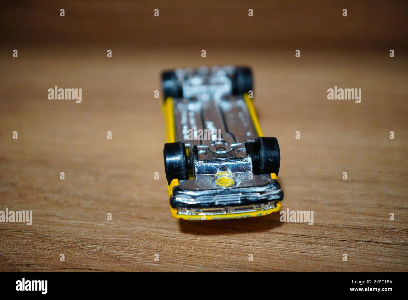 A Mattel Hot Wheels yellow toy model Chevrolet car laying upside down ...