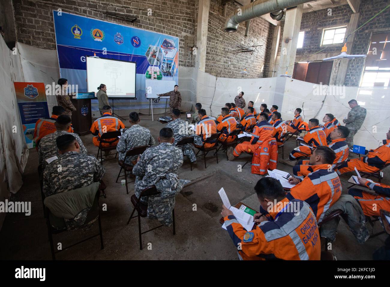A Mongolia National Emergency Management Agency team takes notes on ...