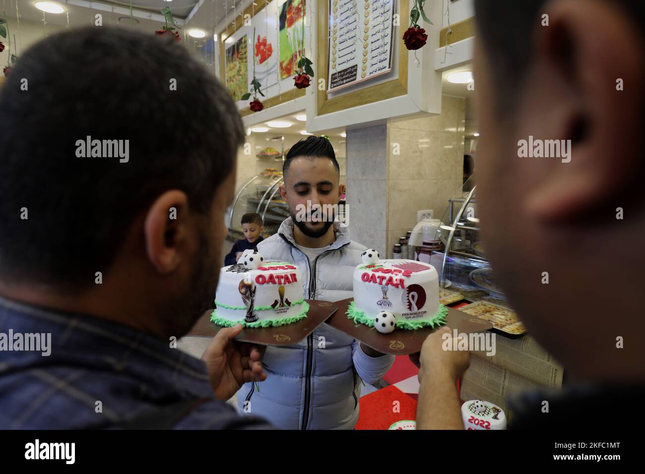 A Palestinian baker shows a cake decorated with items linked to Qatar's ...