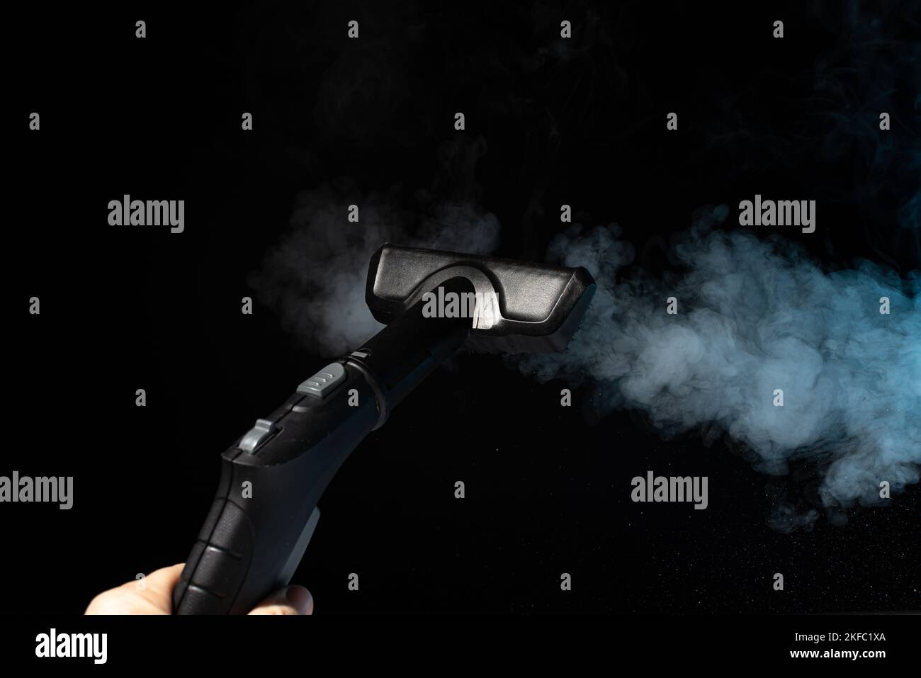 Disinfection with a steam cleaner. Steam on a black background Stock ...