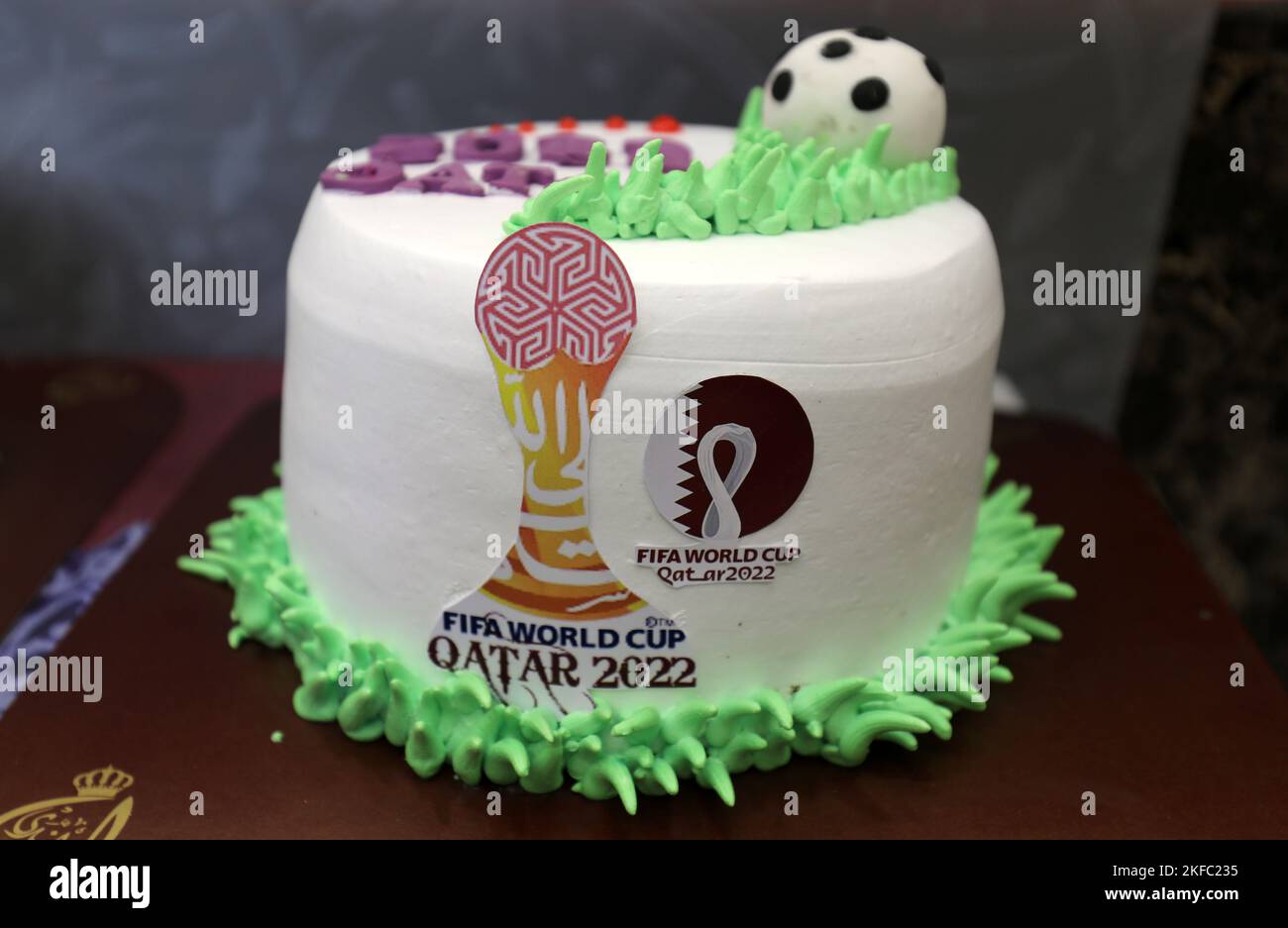 A Palestinian baker shows a cake decorated with items linked to Qatar's ...