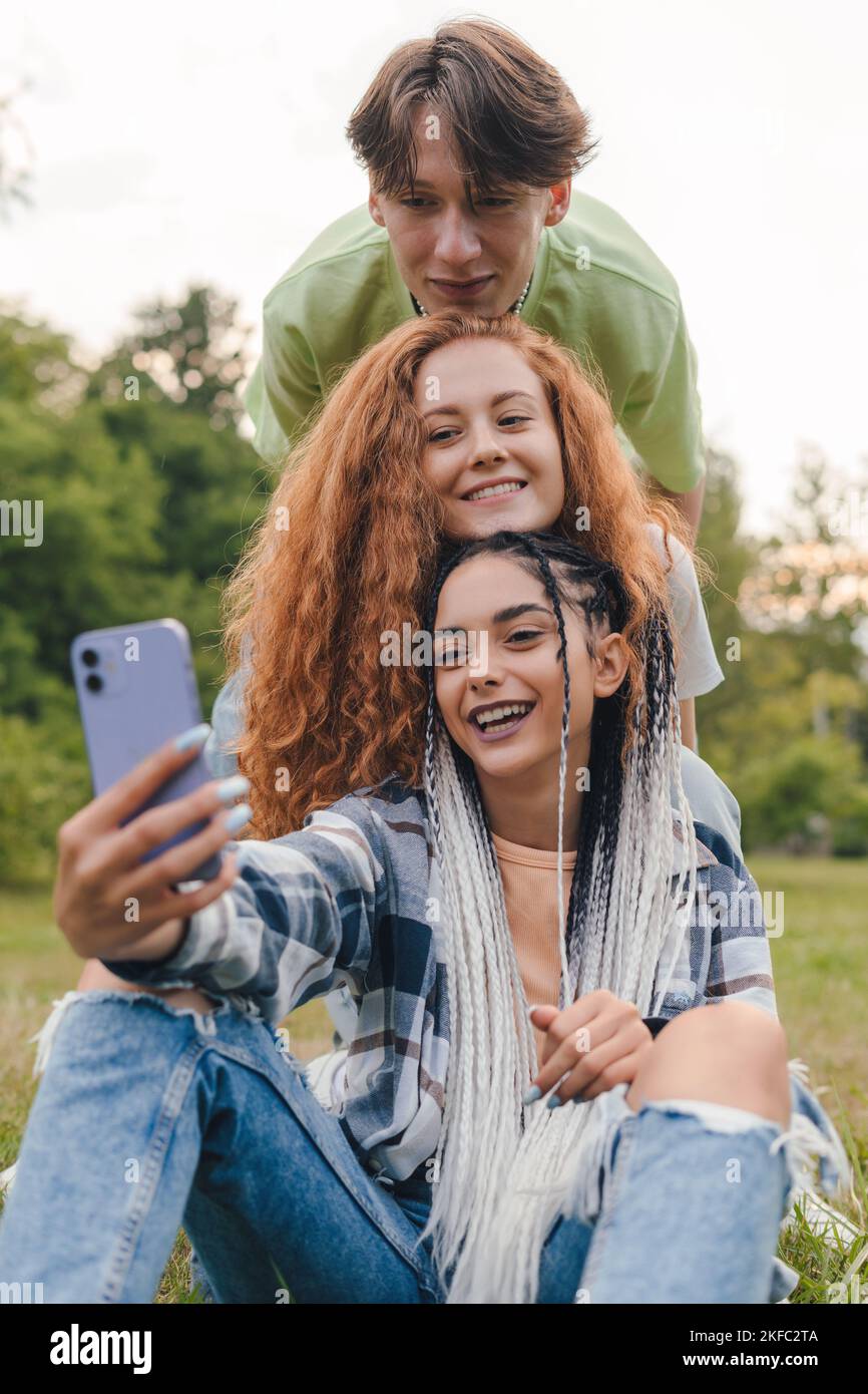 Group of diverse millennials people recording a video or taking a photo ...
