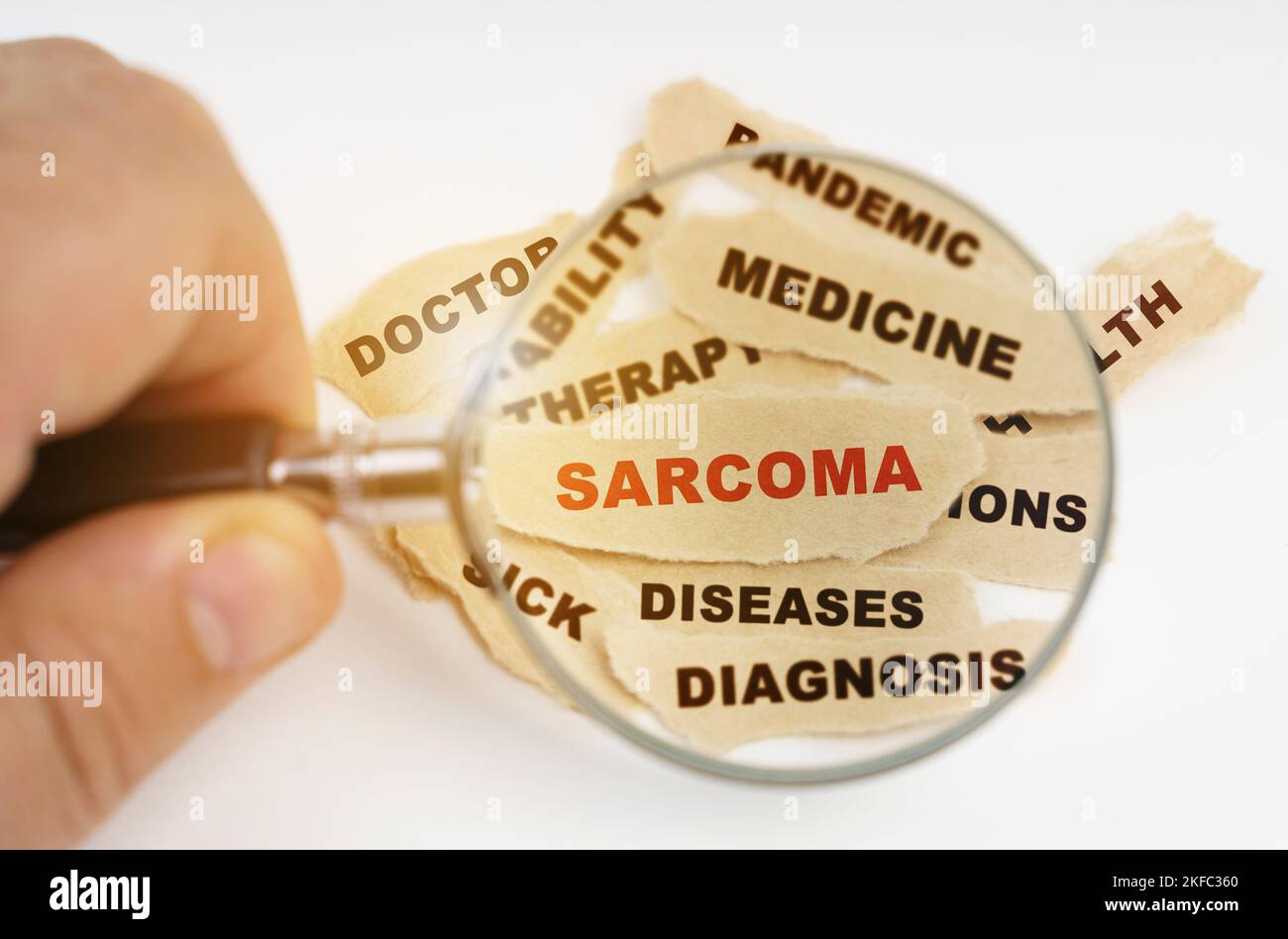 Medical concept. A man looks through a magnifying glass at scraps of ...