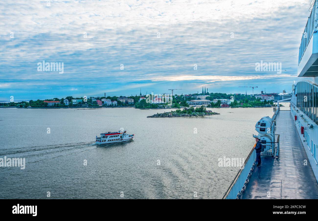 Bay of Helsinki in twilights - sunset. Pleasure boat with people ...