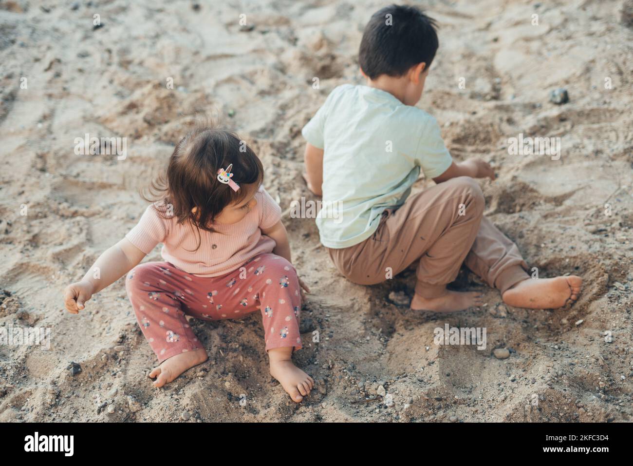 Sweet little kids playing in sand, enjoying nature in country garden ...
