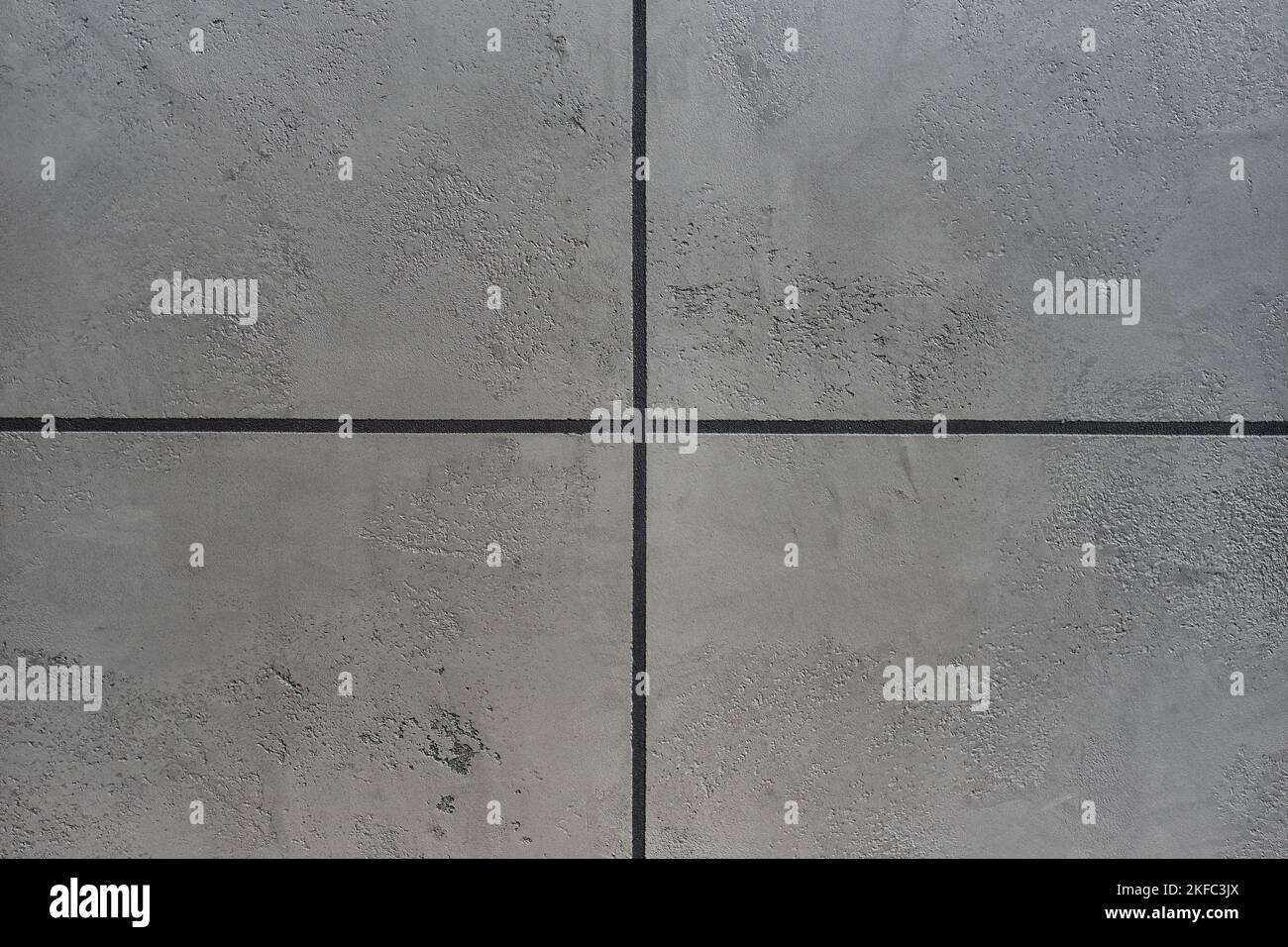 A close-up shot of concrete tiles separated with black glue lines Stock ...