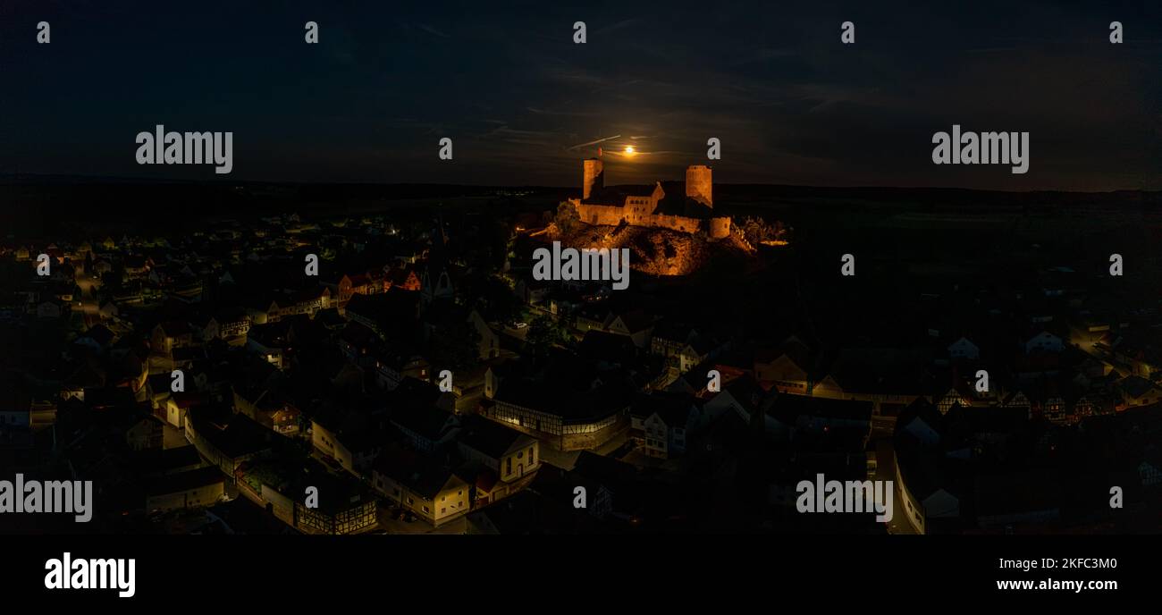 Image of illuminated Muenzenberg castle ruins in Germany in the evening ...