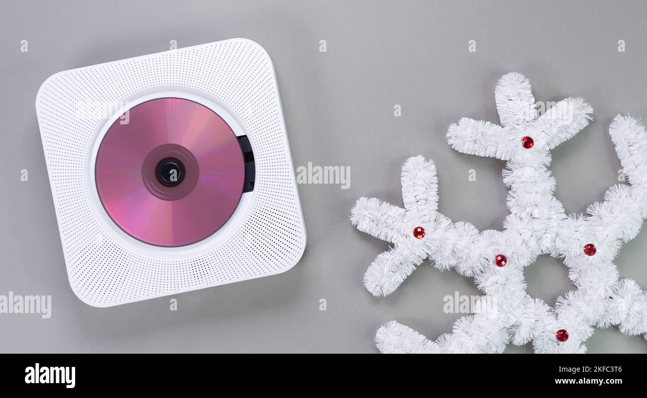 Stylish white portable compact CD player with pink cd disc playing ...
