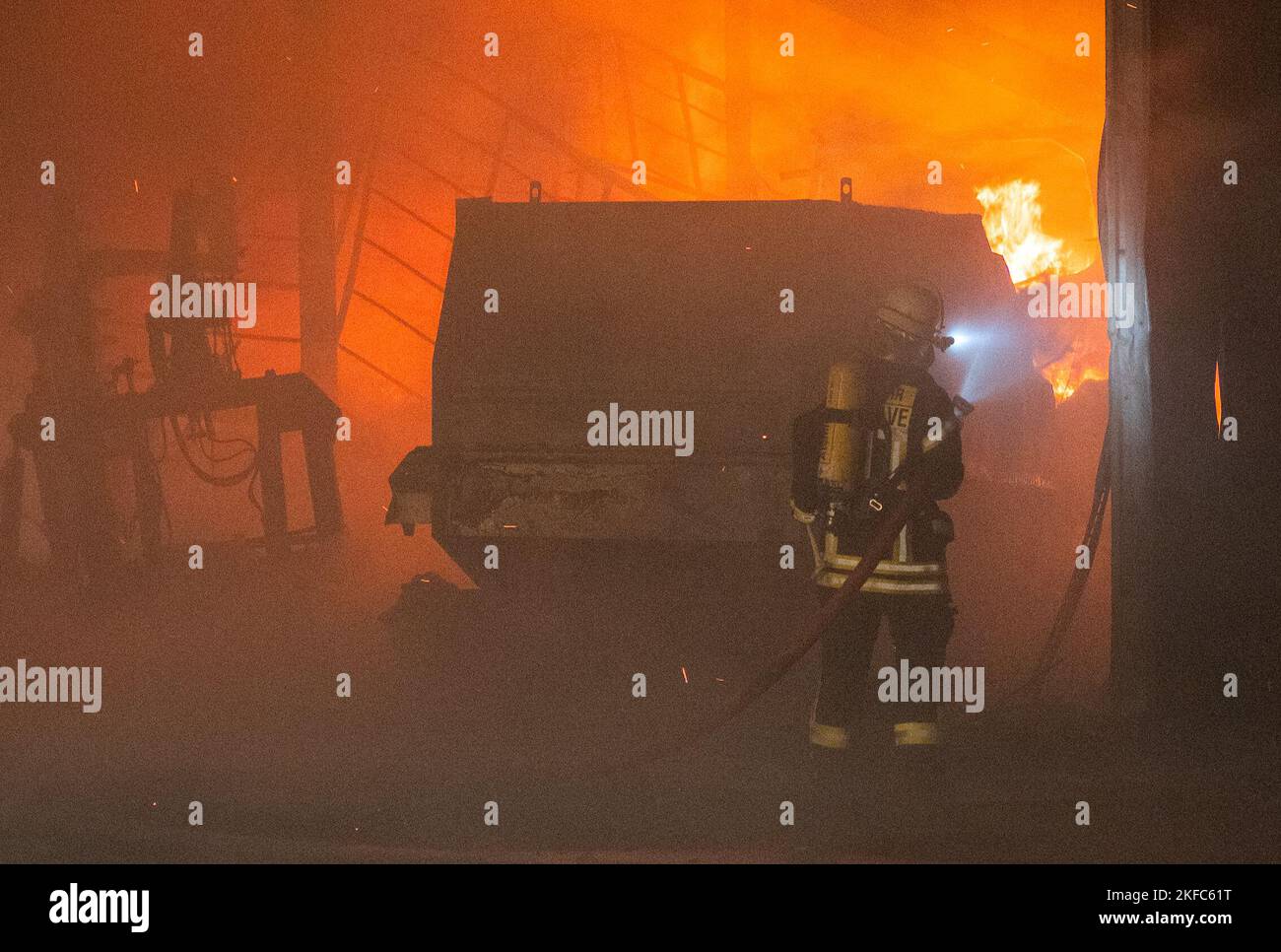 Witzhave, Germany. 17th Nov, 2022. A firefighter extinguishes the large ...