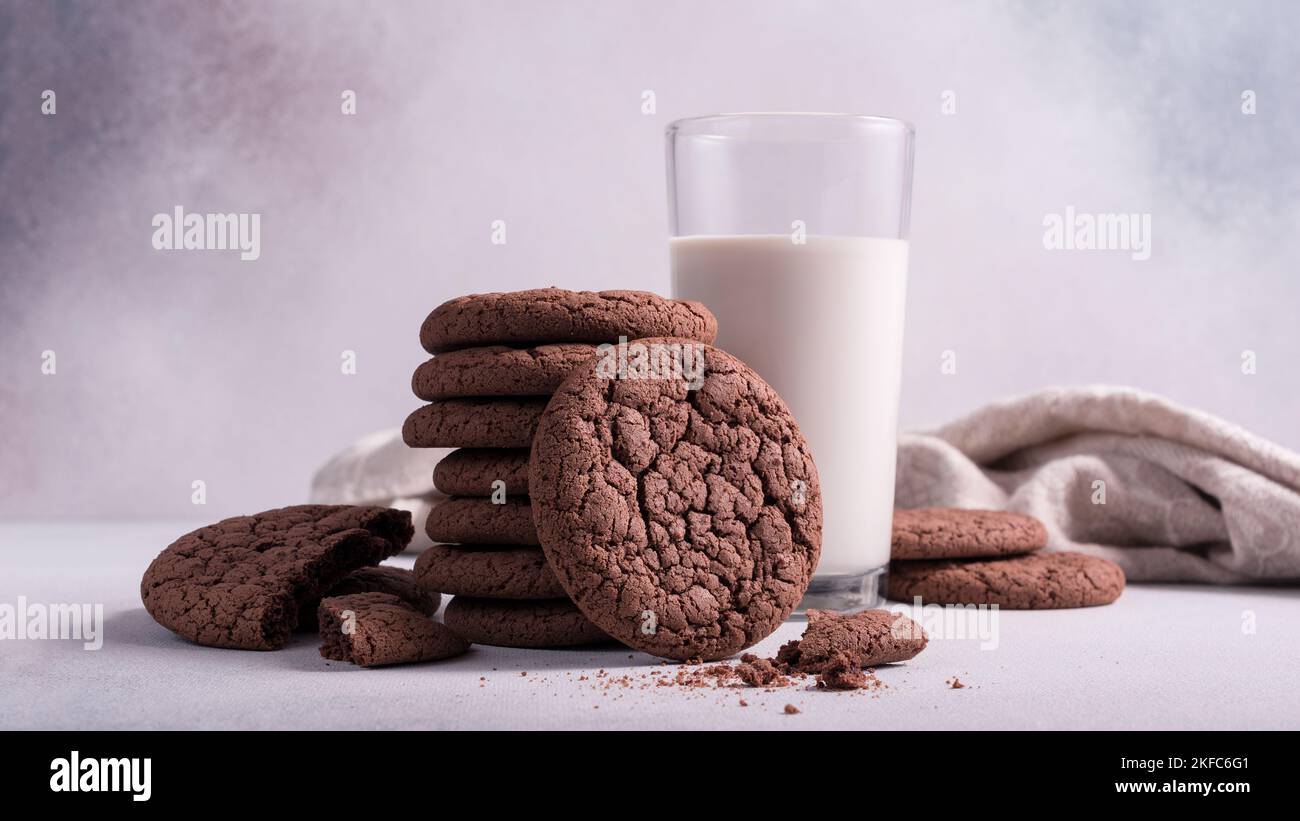 Homemade tasty american chocolate cookies with glass of milk on grey ...